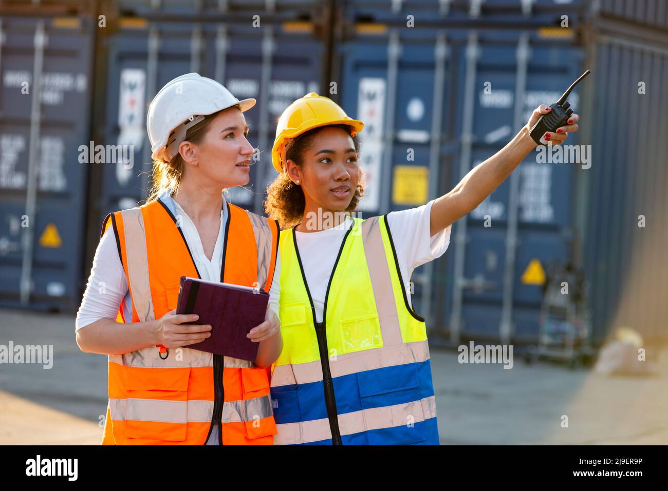 Businesswoman and logistics woman worker checking containers box and ...