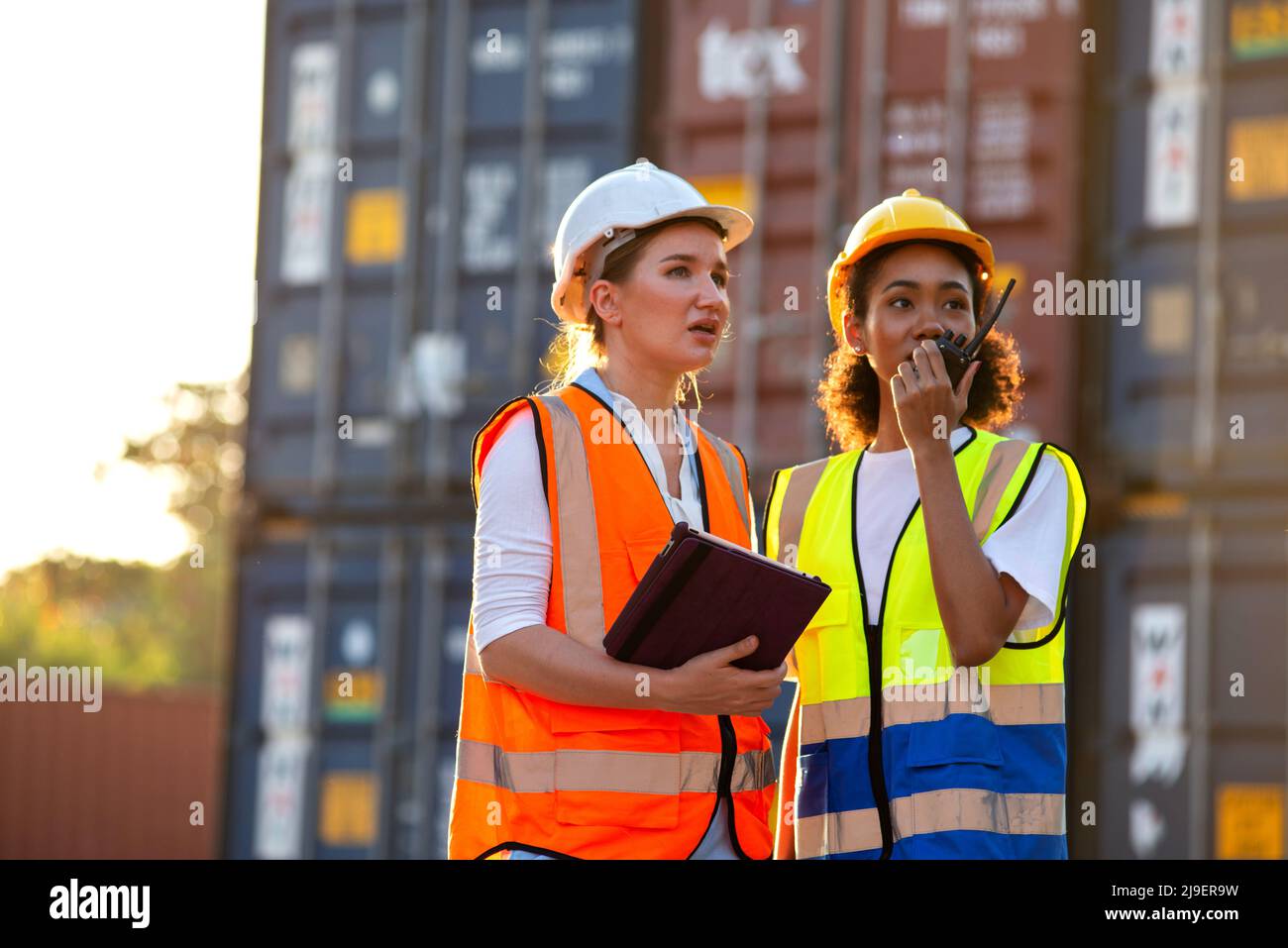 Businesswoman and logistics woman worker checking containers box and ...