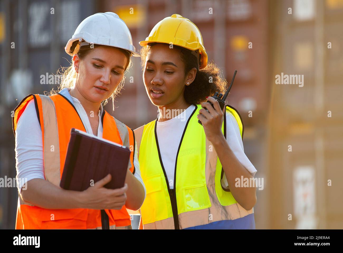 Businesswoman and logistics woman worker checking containers box and ...