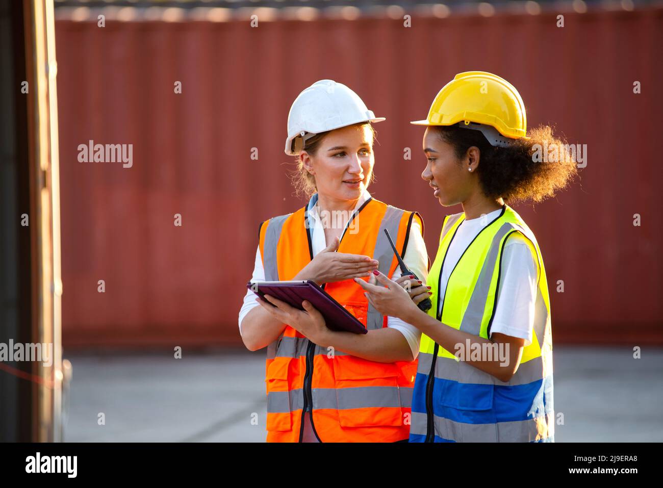 Businesswoman and logistics woman worker checking containers box and ...