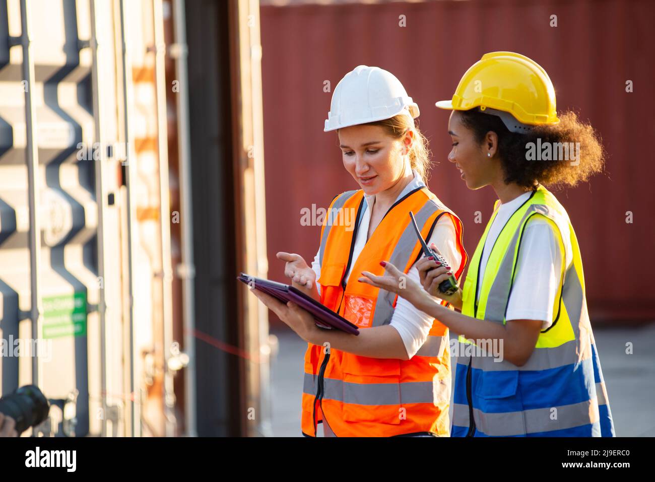 Businesswoman and logistics woman worker checking containers box and ...