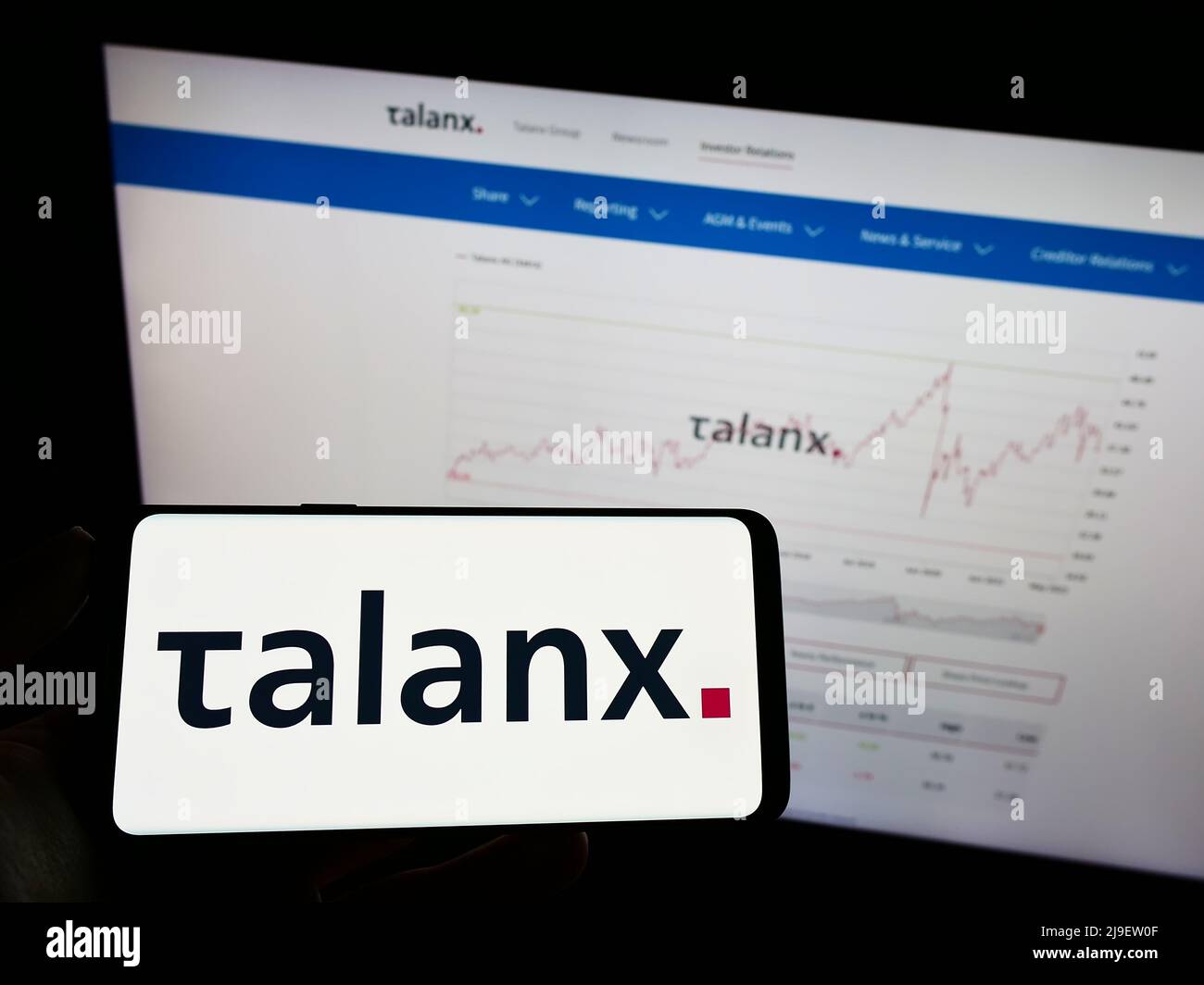 Person holding mobile phone with logo of German financial services ...