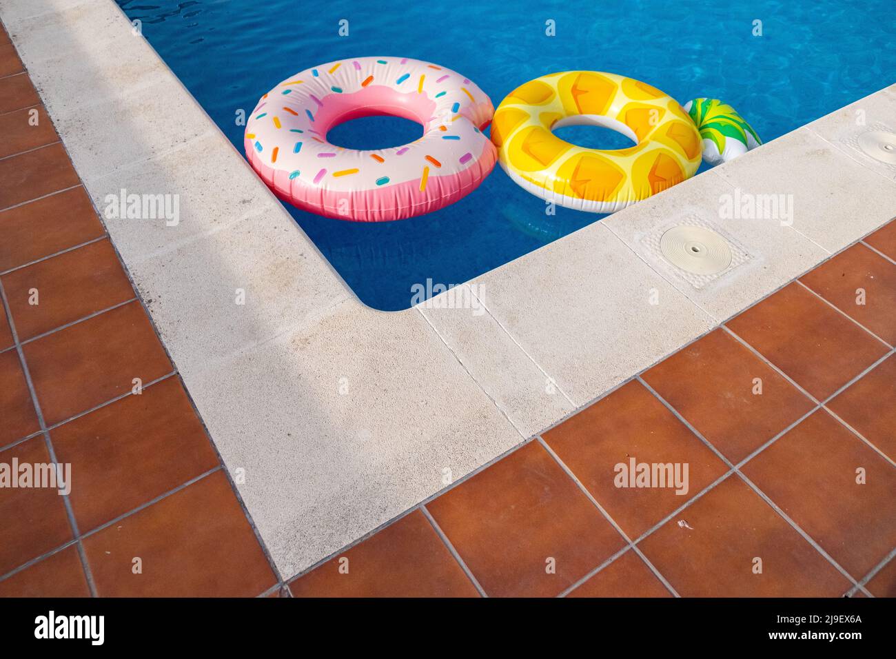 Colored floats in the water of a swimming pool, summer concept Stock ...