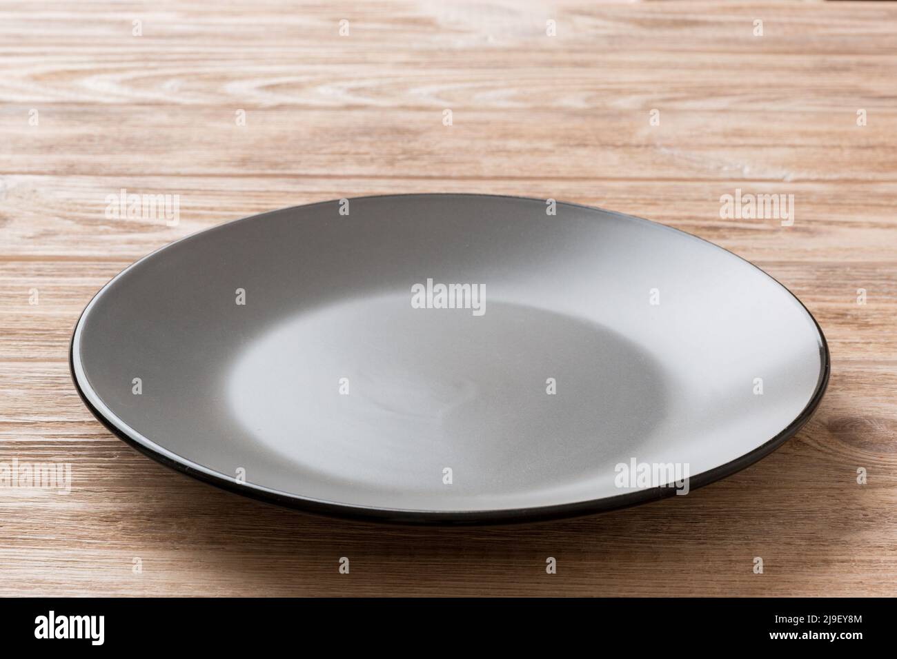 Perspective view of empty grey plate on cement background. Empty space ...