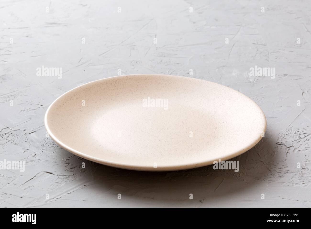 Perspective view of empty light plate on wooden background. Empty space ...