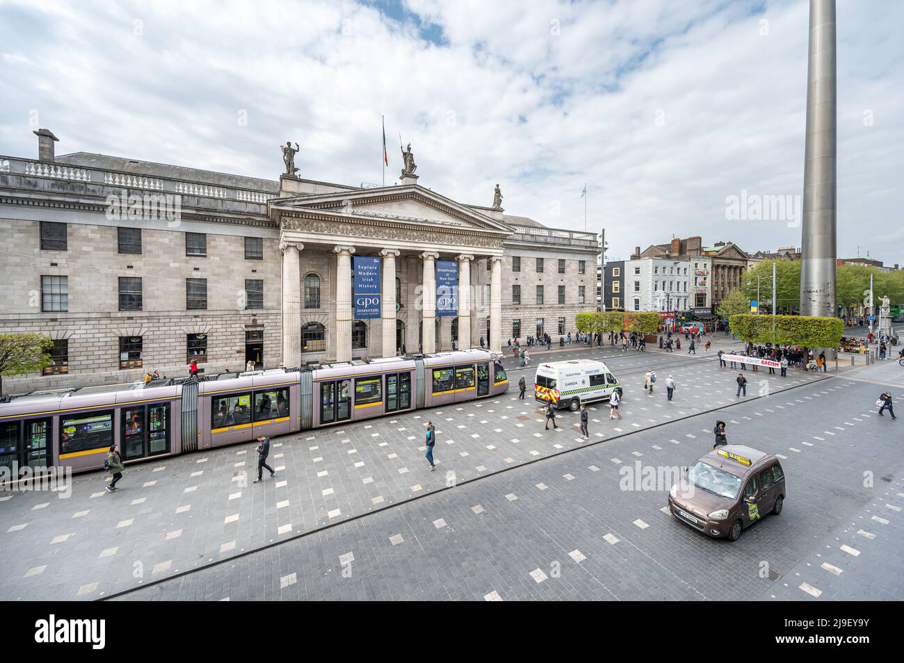 Luas tram passes in front of the GPO and Dublin Spire on a busy O ...