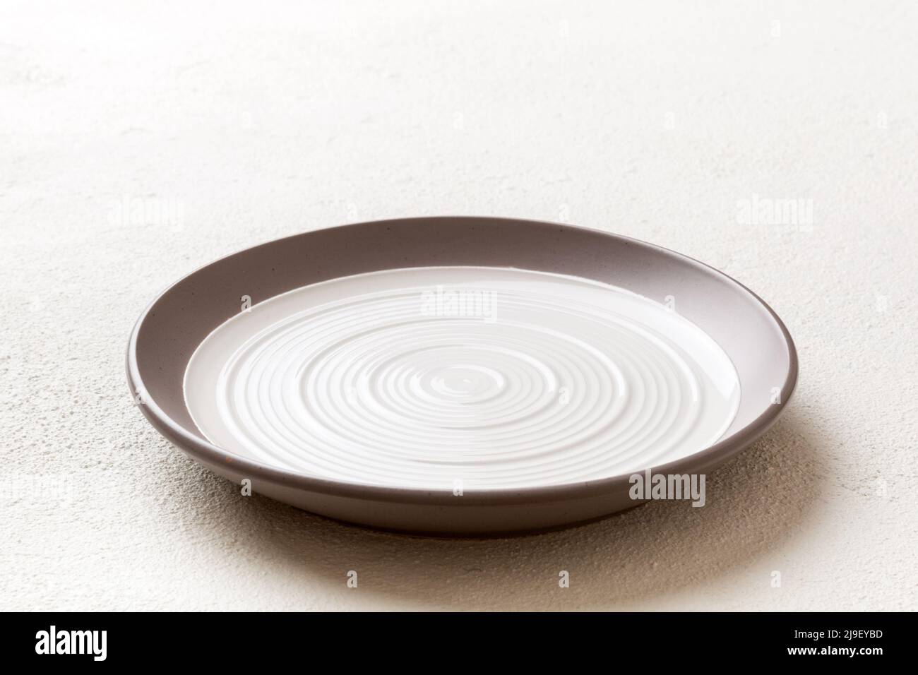 Perspective view of empty light plate on wooden background. Empty space ...