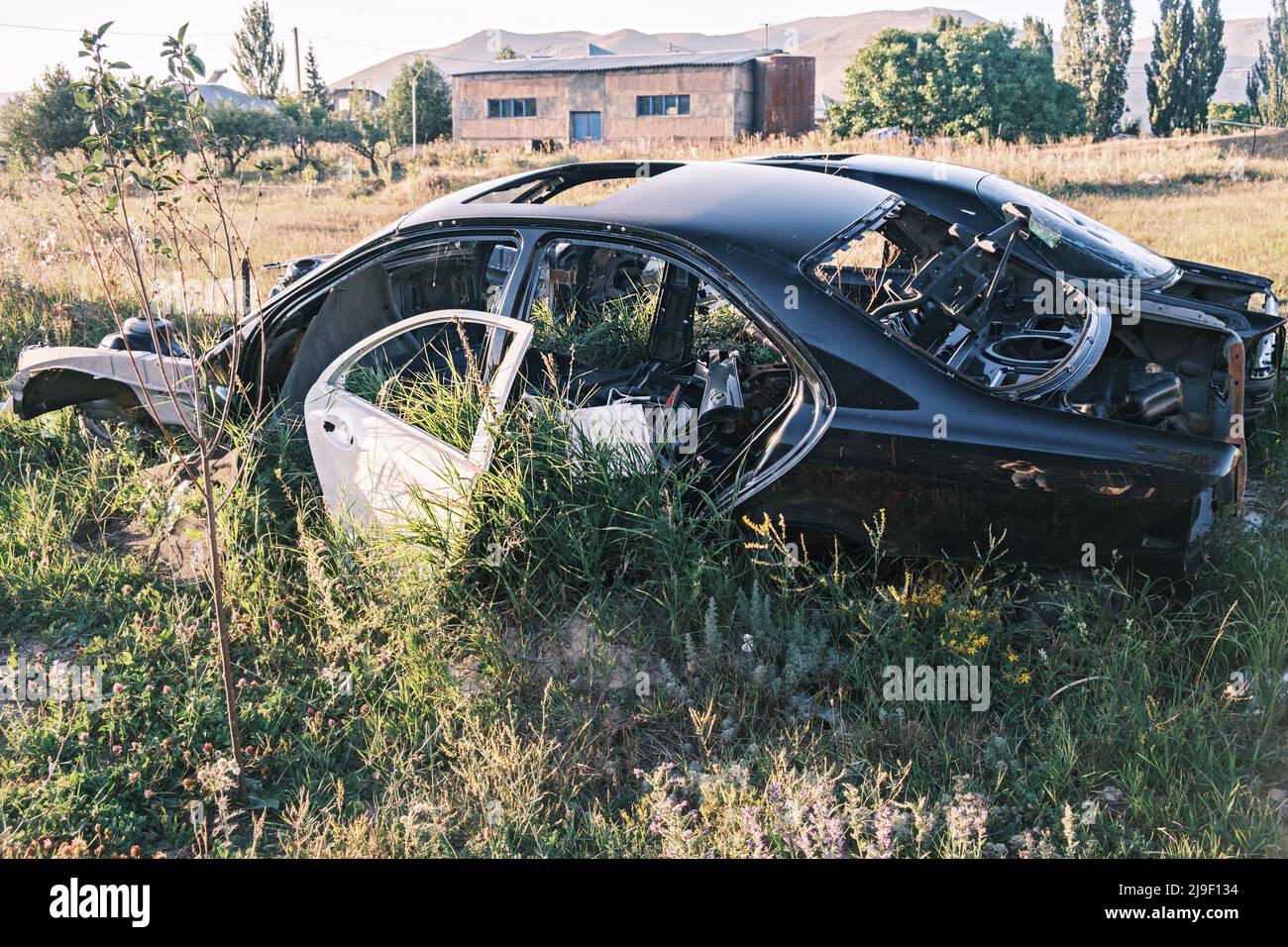 Car dump, scrap metal. Close-up of an old abandoned car in a junkyard ...