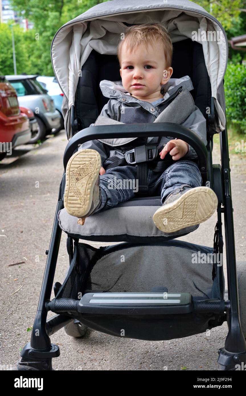 Portrait of cute little boy in stroller Stock Photo - Alamy