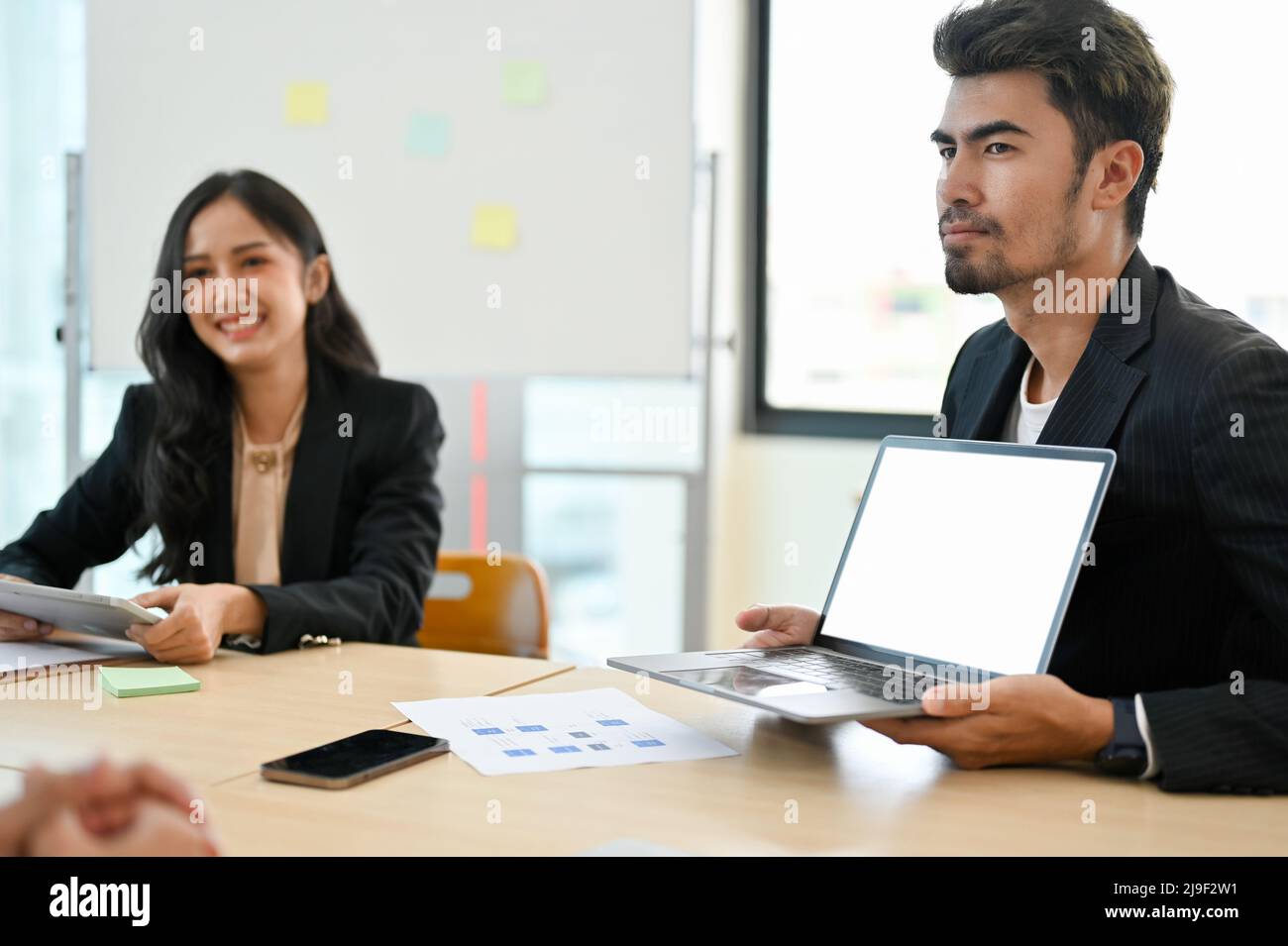 Professional Asian male financial analyst is presenting his financial ...