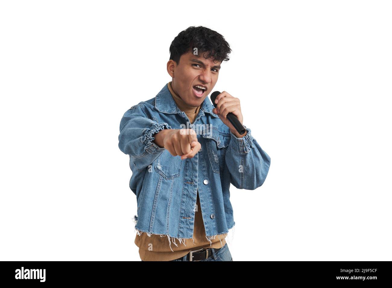 Young peruvian man singing with a microphone, isolated Stock Photo - Alamy