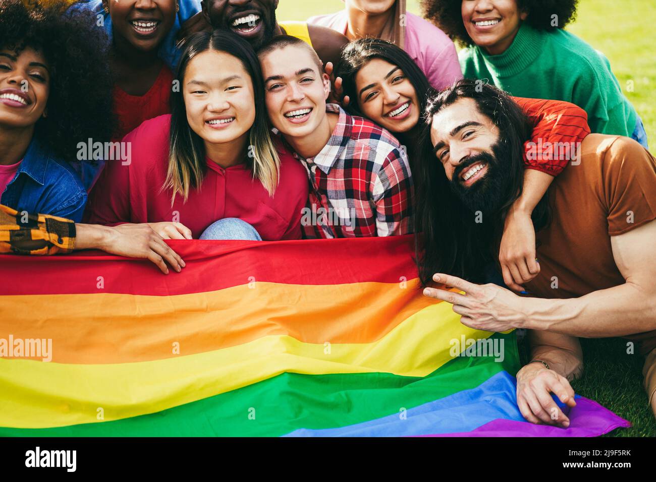 Diverse people having fun holding LGBT rainbow flag outdoor Stock Photo ...