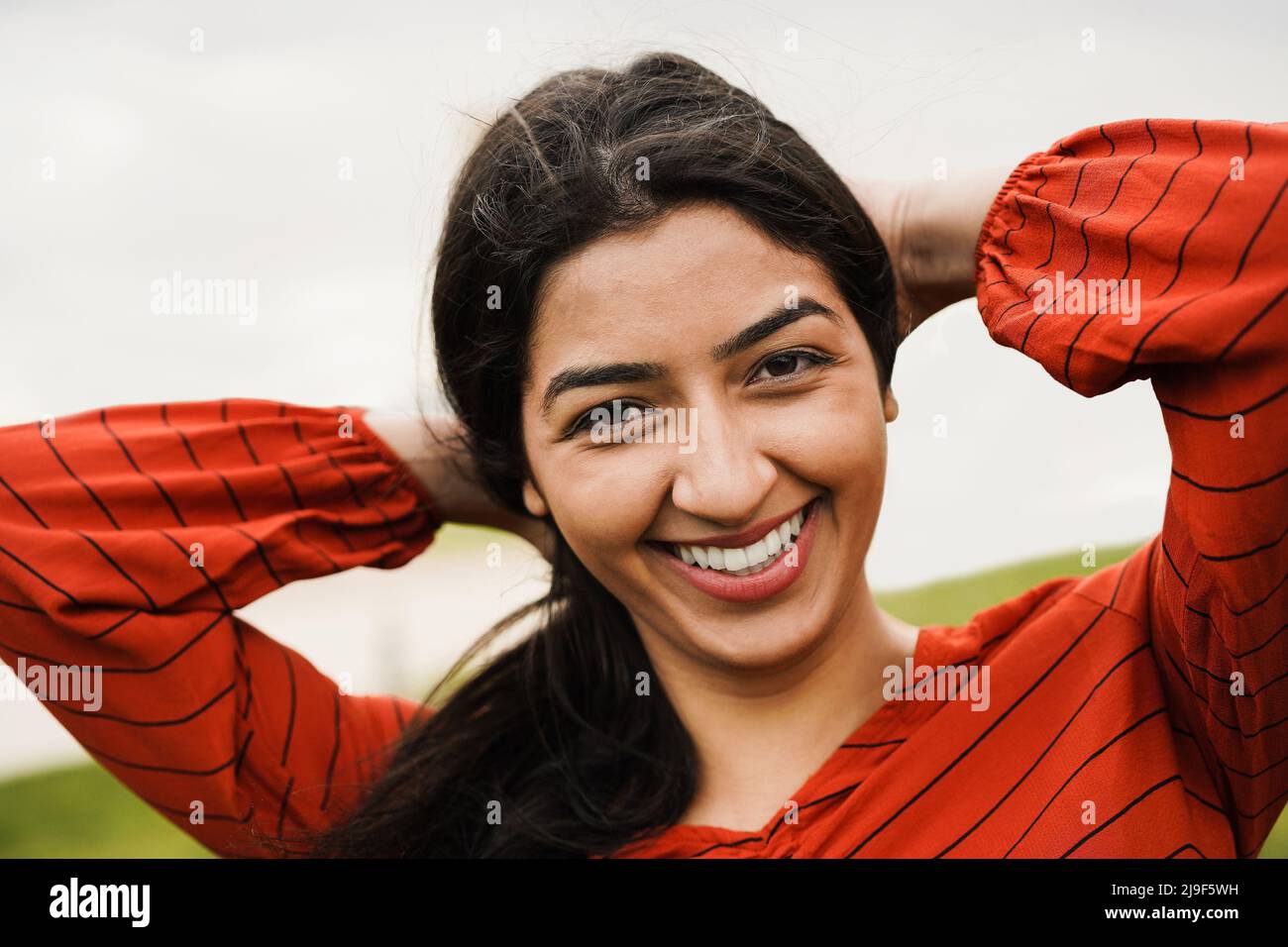 Indian girl smiling on camera at city park - Focus on face Stock Photo ...