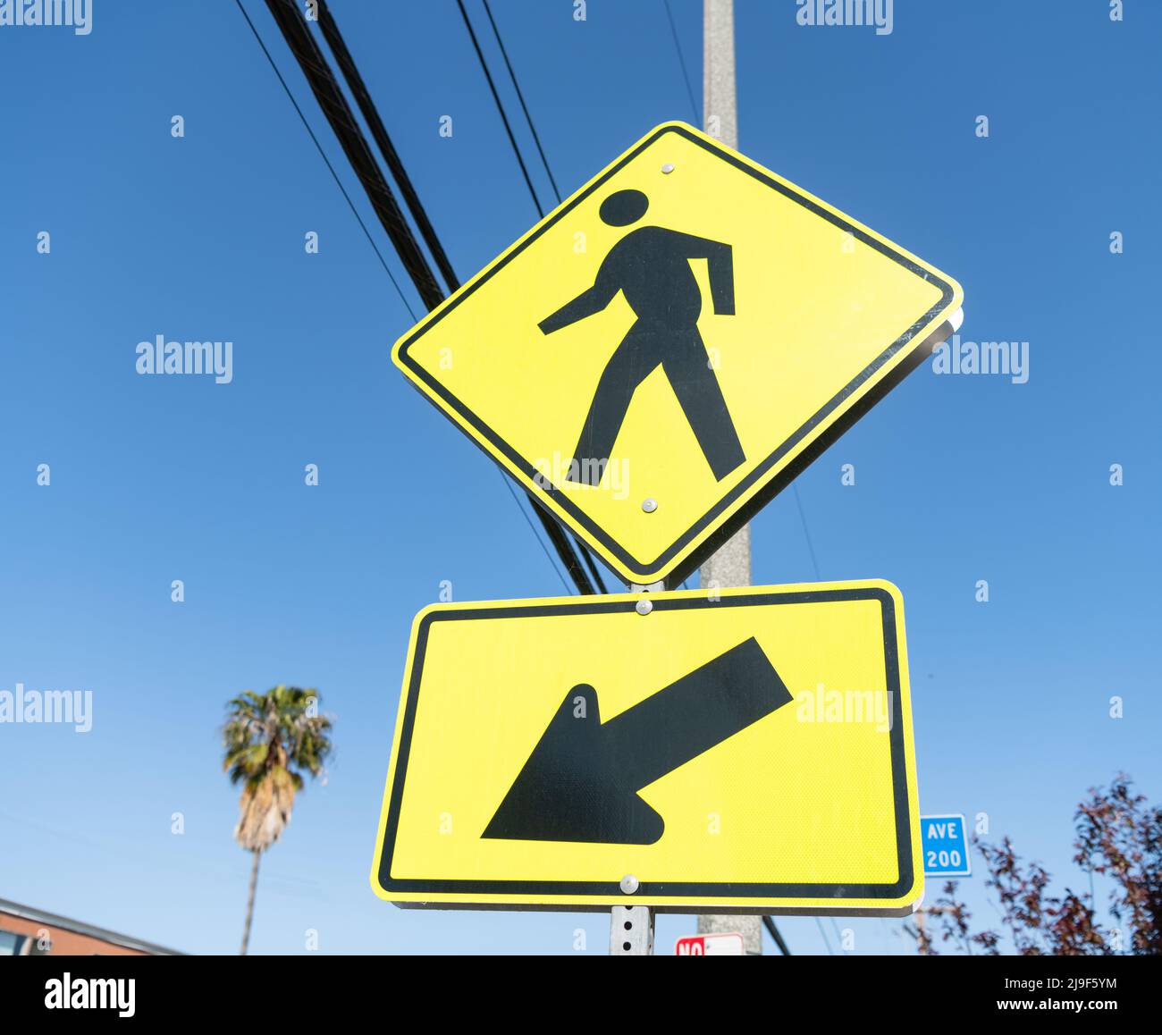 yellow road sign for pedestrian directing this way Stock Photo - Alamy
