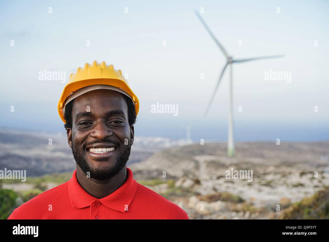 African engineer man working on a windmill farm - Focus on face Stock ...