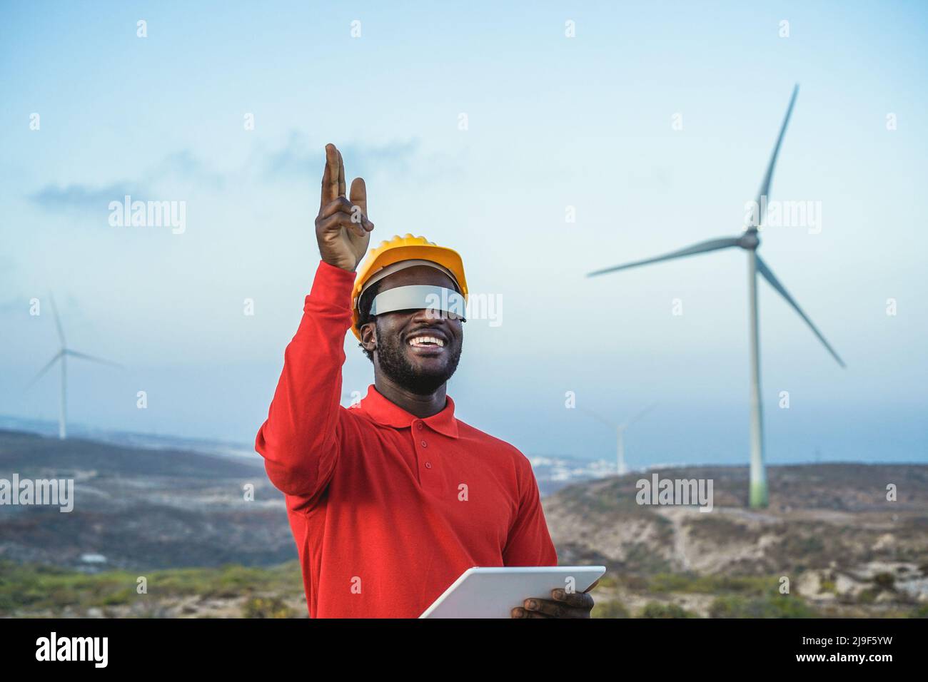 African engineer man using futuristic augmented reality glasses on a ...