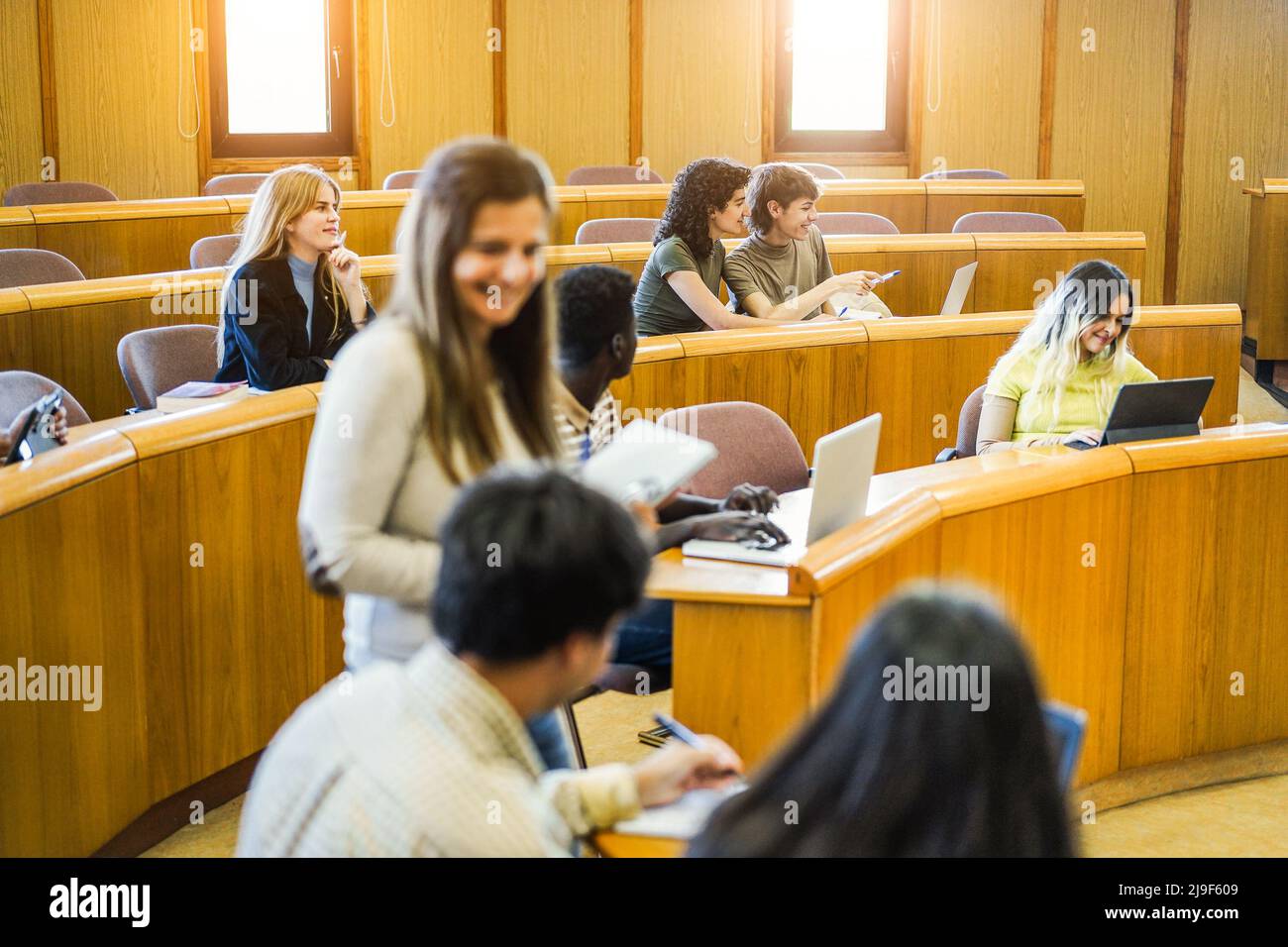 Mature teacher working inside classroom at school university - Focus on ...