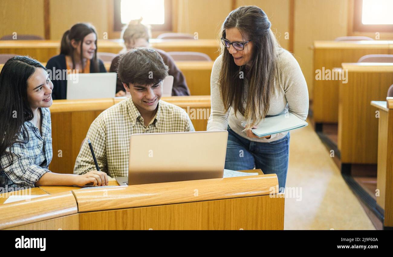 Teacher working with students inside classroom at school university ...