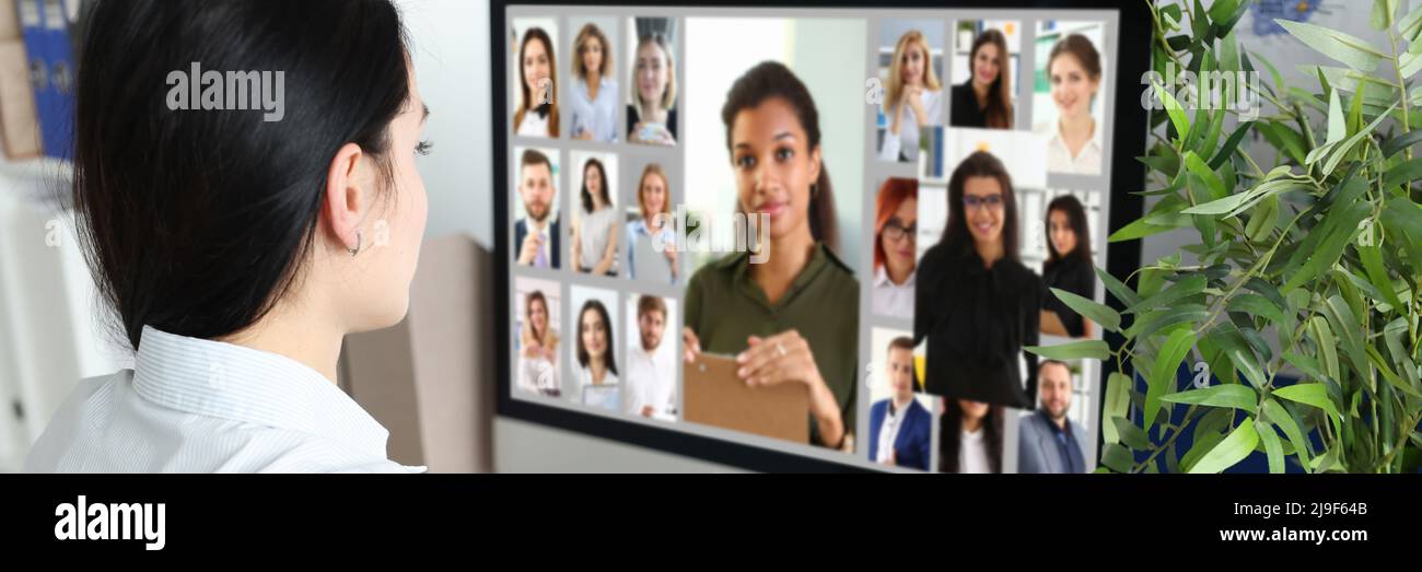 Woman looking at the display screen at the photo of people Stock Photo ...