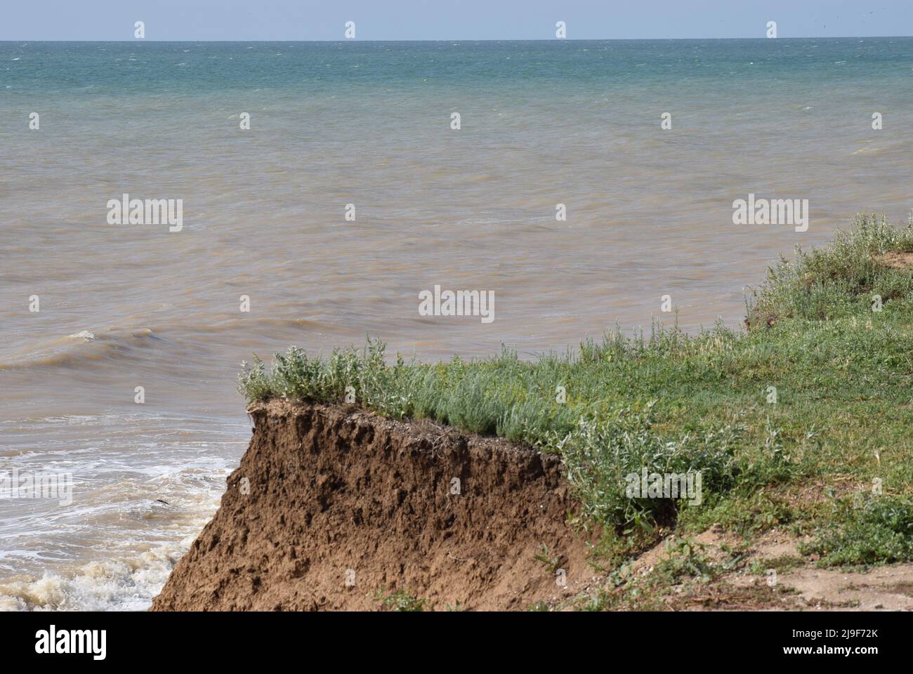 Clay Cliffs and Beach with Blue Sky and Water Stock Photo - Alamy