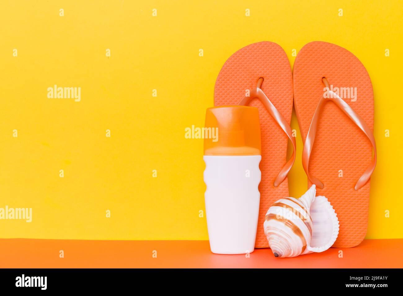 Beach accessories. Flip flops and starfish on colored background. Mock ...