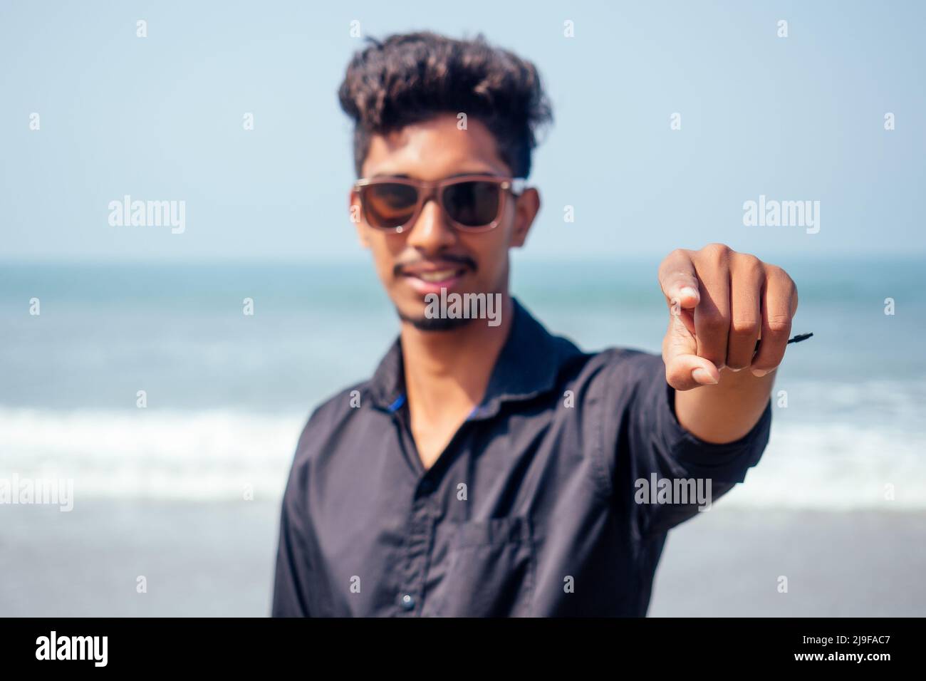 Asian Indian man finger pointing at you focus Stock Photo - Alamy