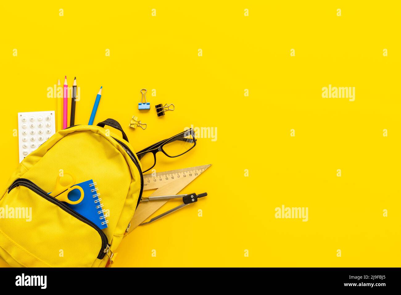 Yellow school backpack. Back to school concept. Top view Stock Photo ...