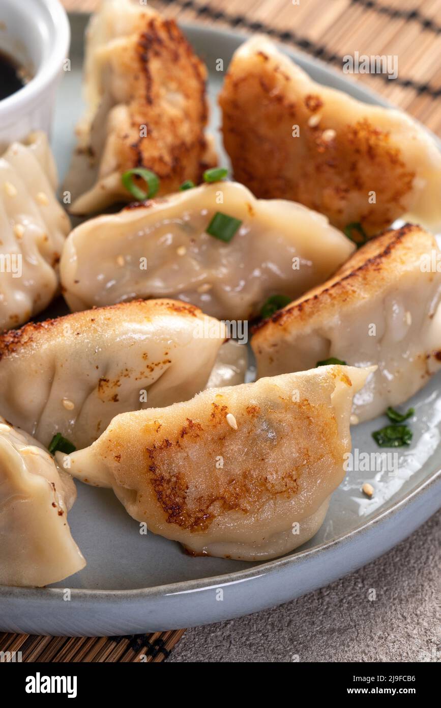 Taiwanese and Japanese Pan-fried gyoza dumpling jiaozi food in a plate ...