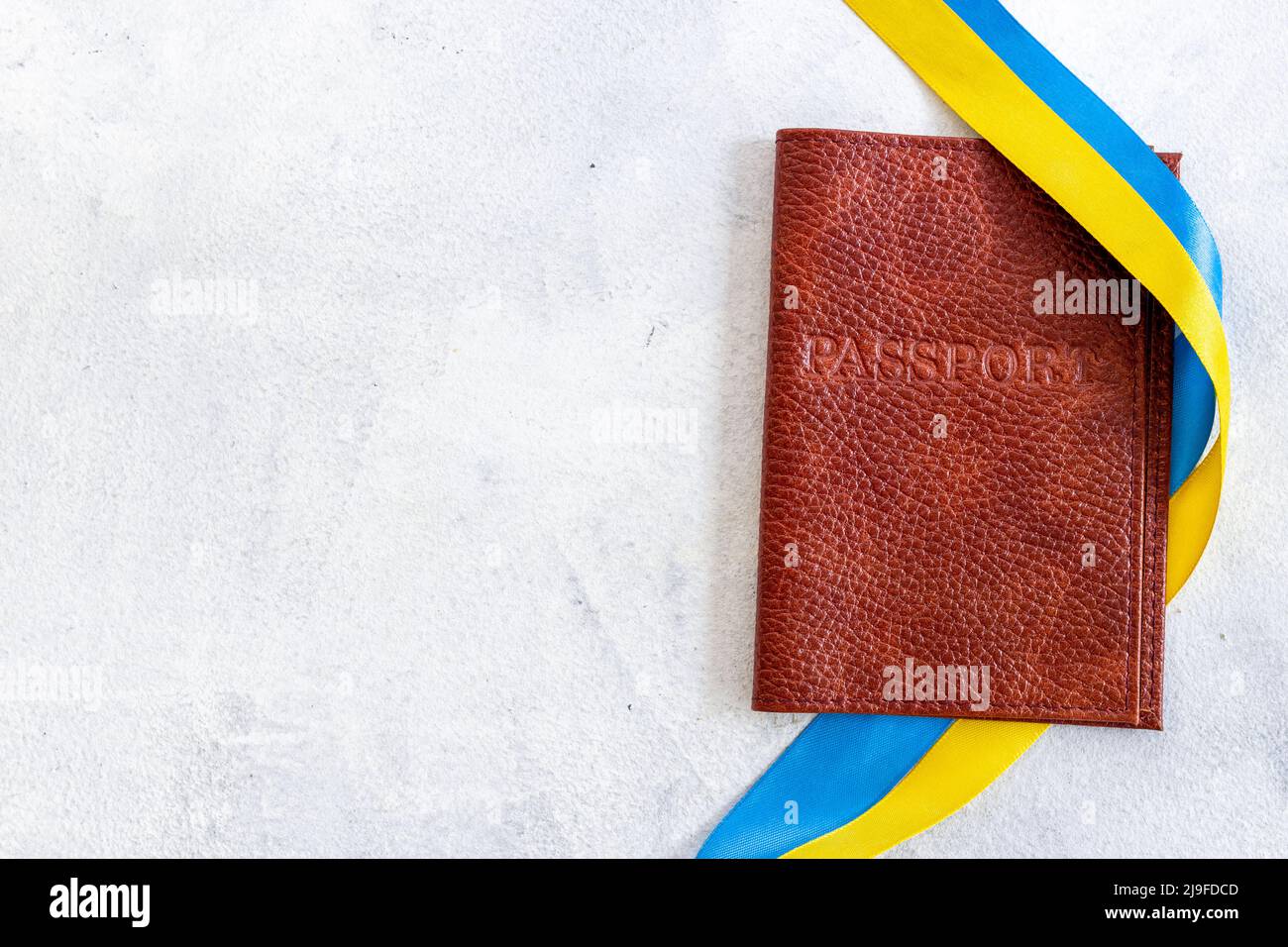 Yellow and blue ribbon with passport. Ukrainian immigration concept ...
