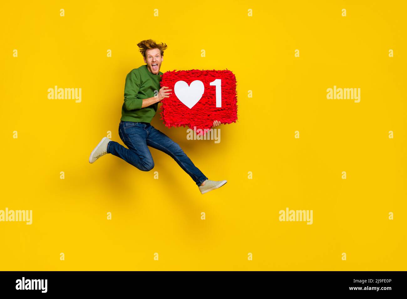 Full length photo of funny cool guy dressed sweater jumping holding ...