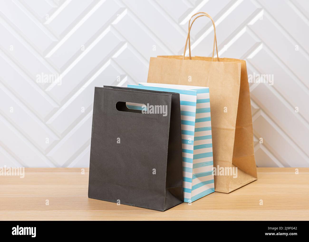 Blank paper carrier bag with handles for shopping, facing front on ...