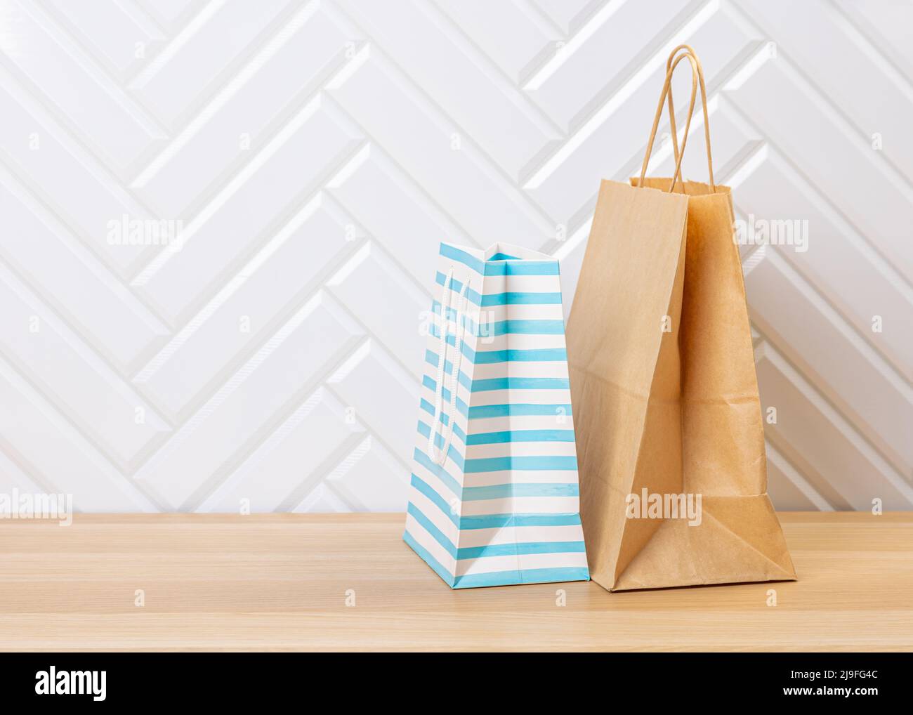 Blank paper carrier bag with handles for shopping, facing front on ...