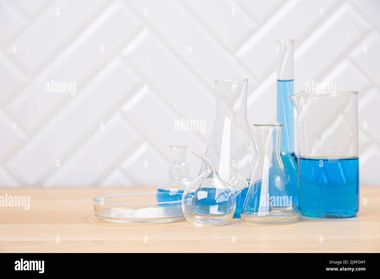 Laboratory glassware with test tubes. flasks, dropper, petri dishes ...