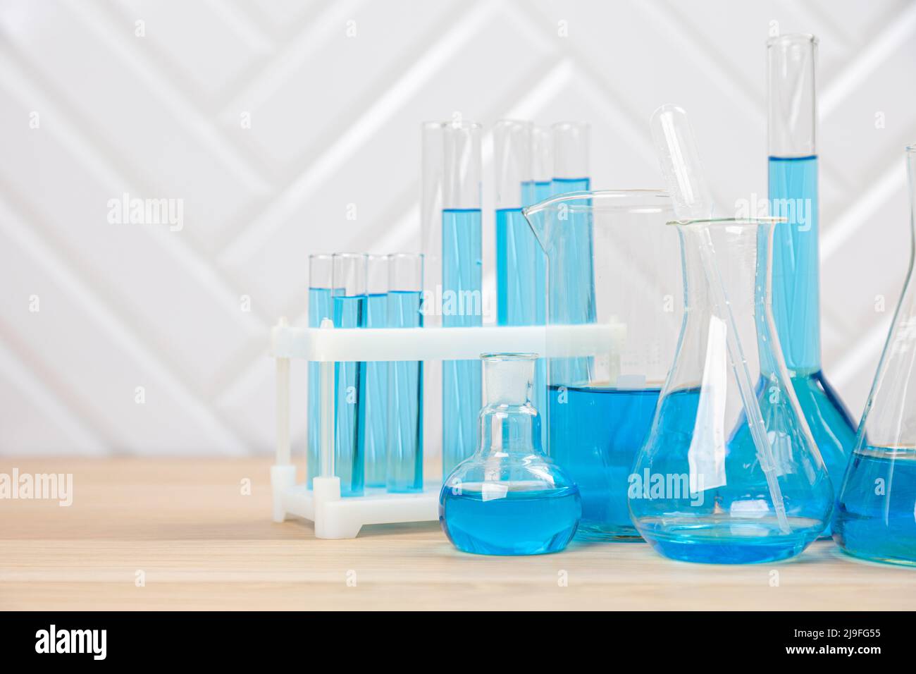 Laboratory glassware with blue liquid in a test tube. scientific ...