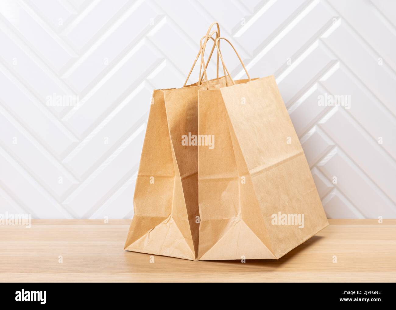Blank paper carrier bag with handles for shopping, facing front on ...