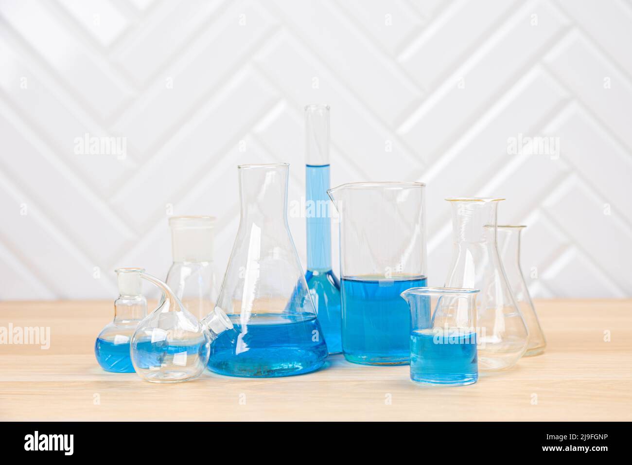Laboratory glassware with test tubes. flasks, dropper, petri dishes ...