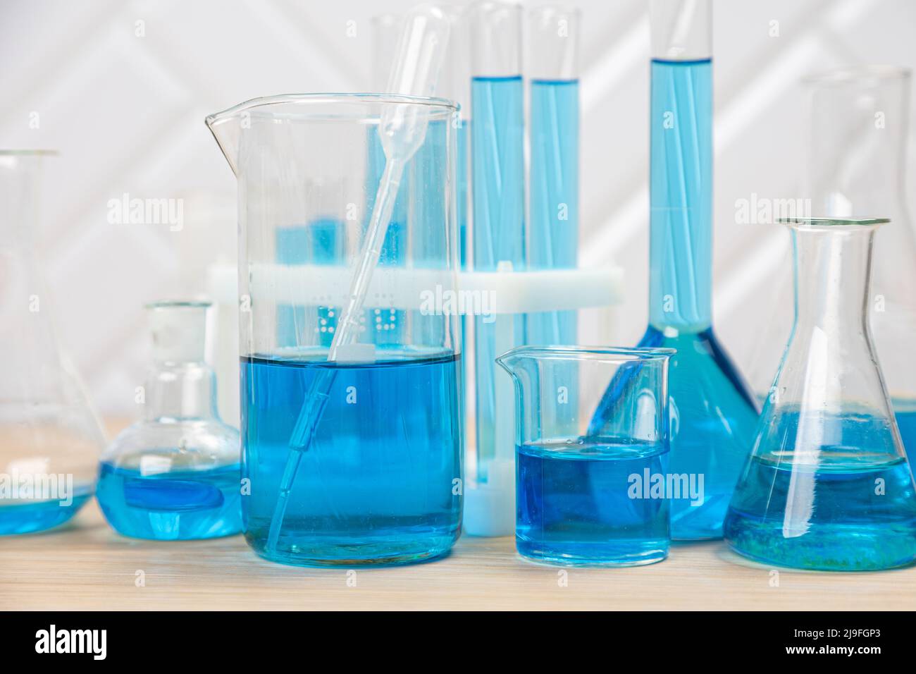 Laboratory glassware with blue liquid in a test tube. scientific ...