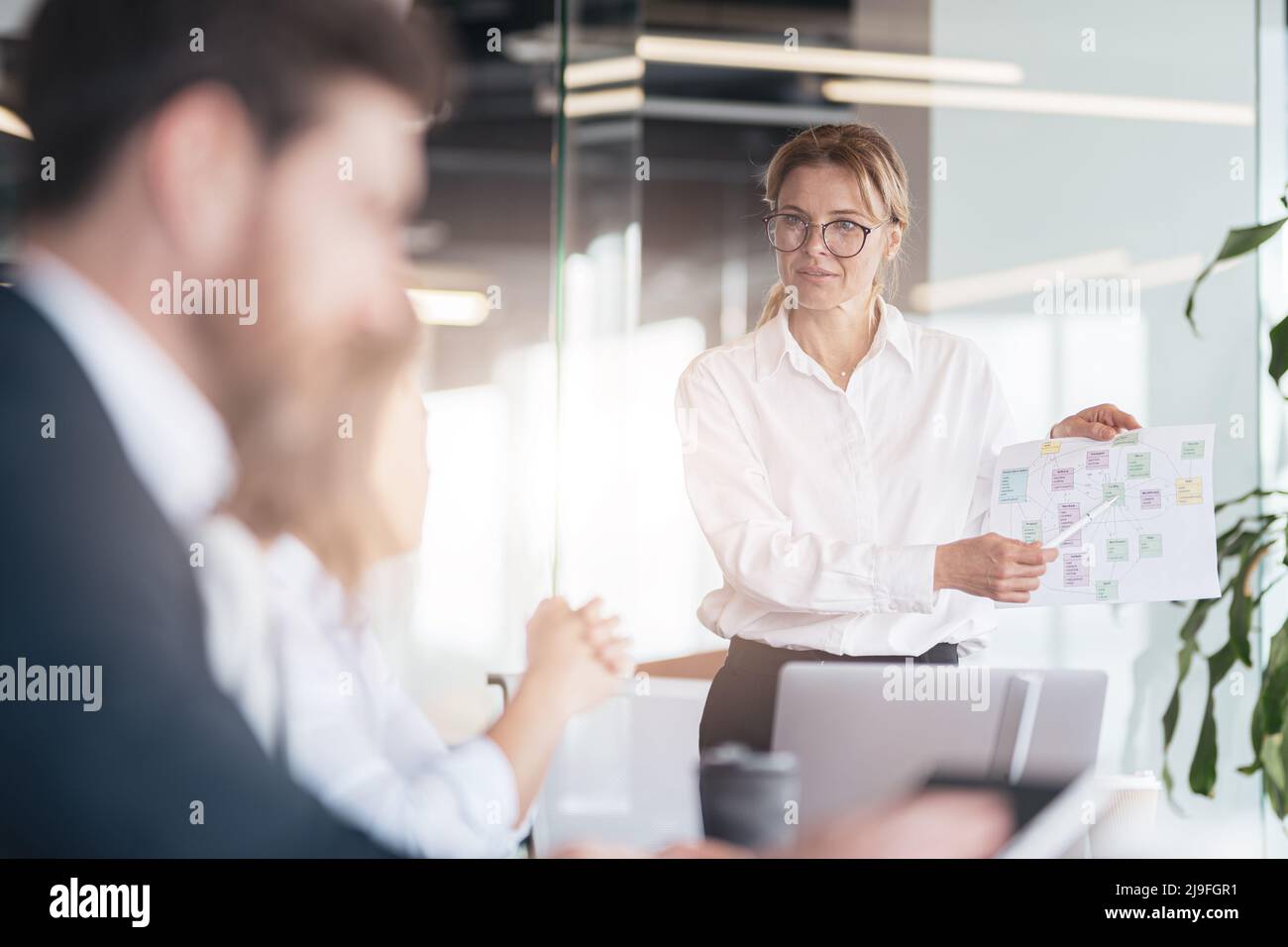 Business woman talking on presentation financial statistics at briefing ...