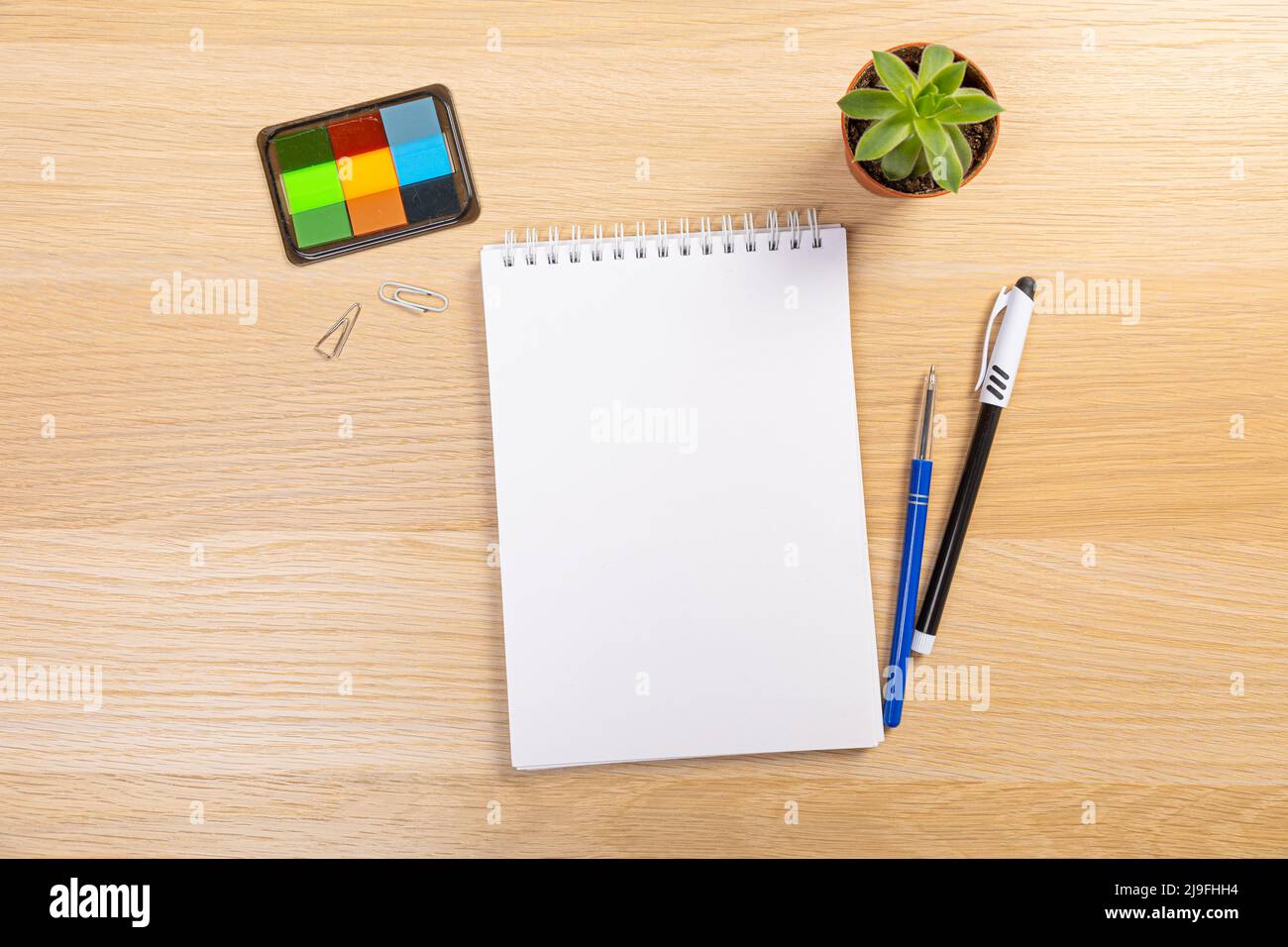 Working table with keyboard and notepad, pen, pencil and plant in home ...