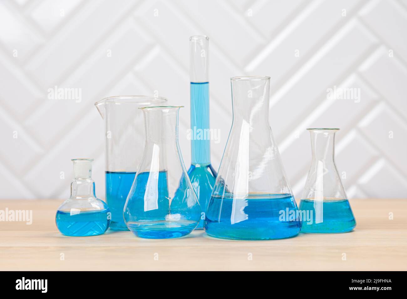 Laboratory glassware with blue liquid in a test tube. scientific ...