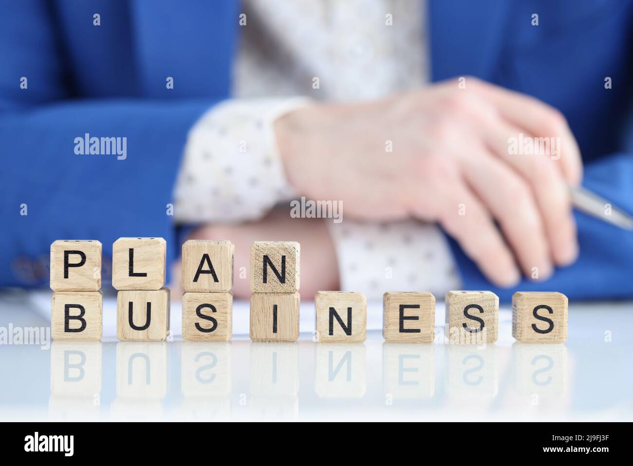 Business plan text on cubes and businessman Stock Photo - Alamy