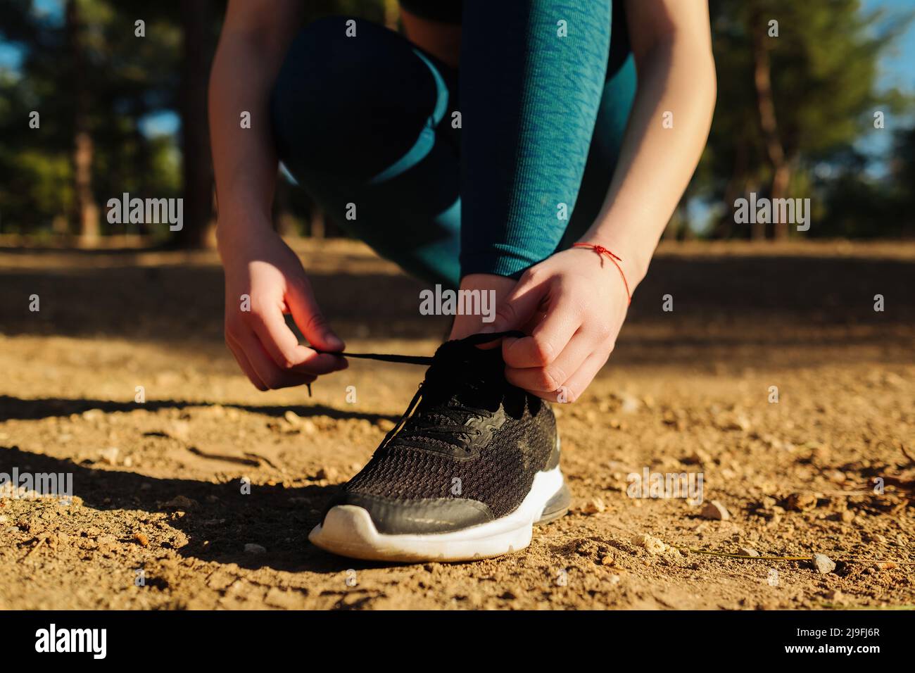 Runner woman wearing blue yoga pants and black sneaker shoes standing ...