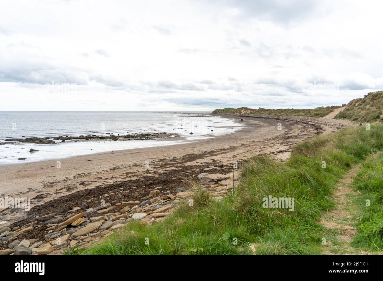 The view at Amble Links beach, Northumberland, UK, with people taking a ...