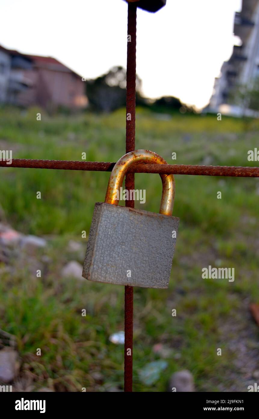 Single rusty love padlock hanging on a grid, eternity love concept ...