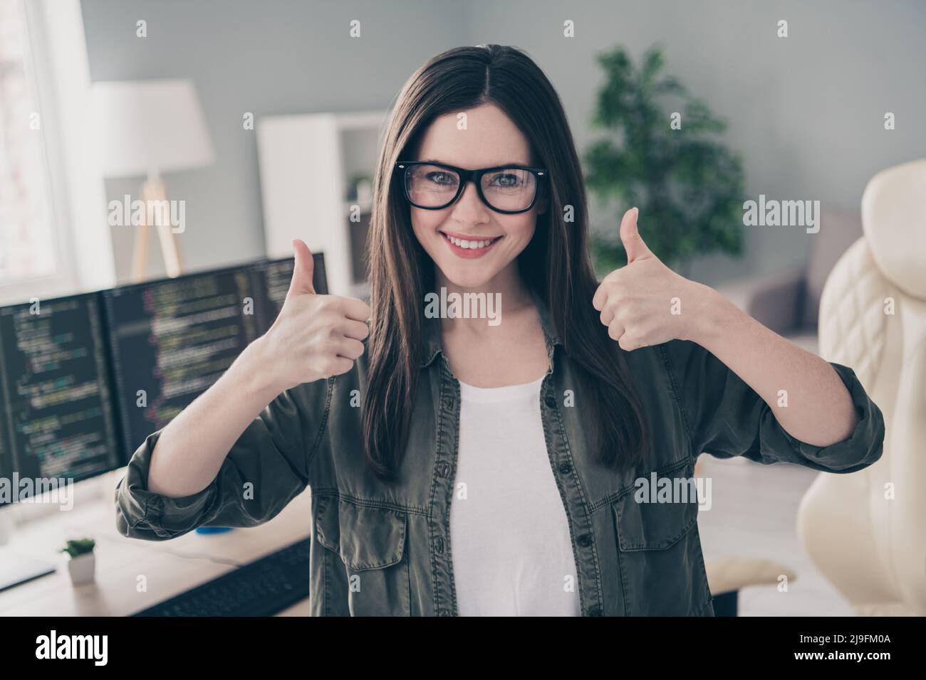 Portrait of beautiful cheerful content girl expert showing double ...