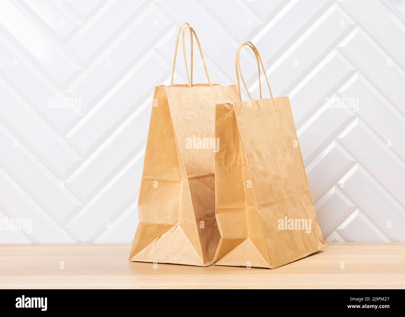 Blank paper carrier bag with handles for shopping, facing front on ...