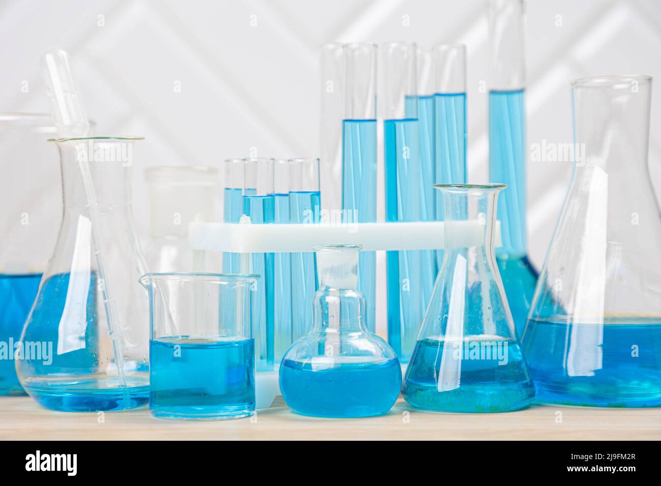 Laboratory glassware with blue liquid in a test tube. scientific ...