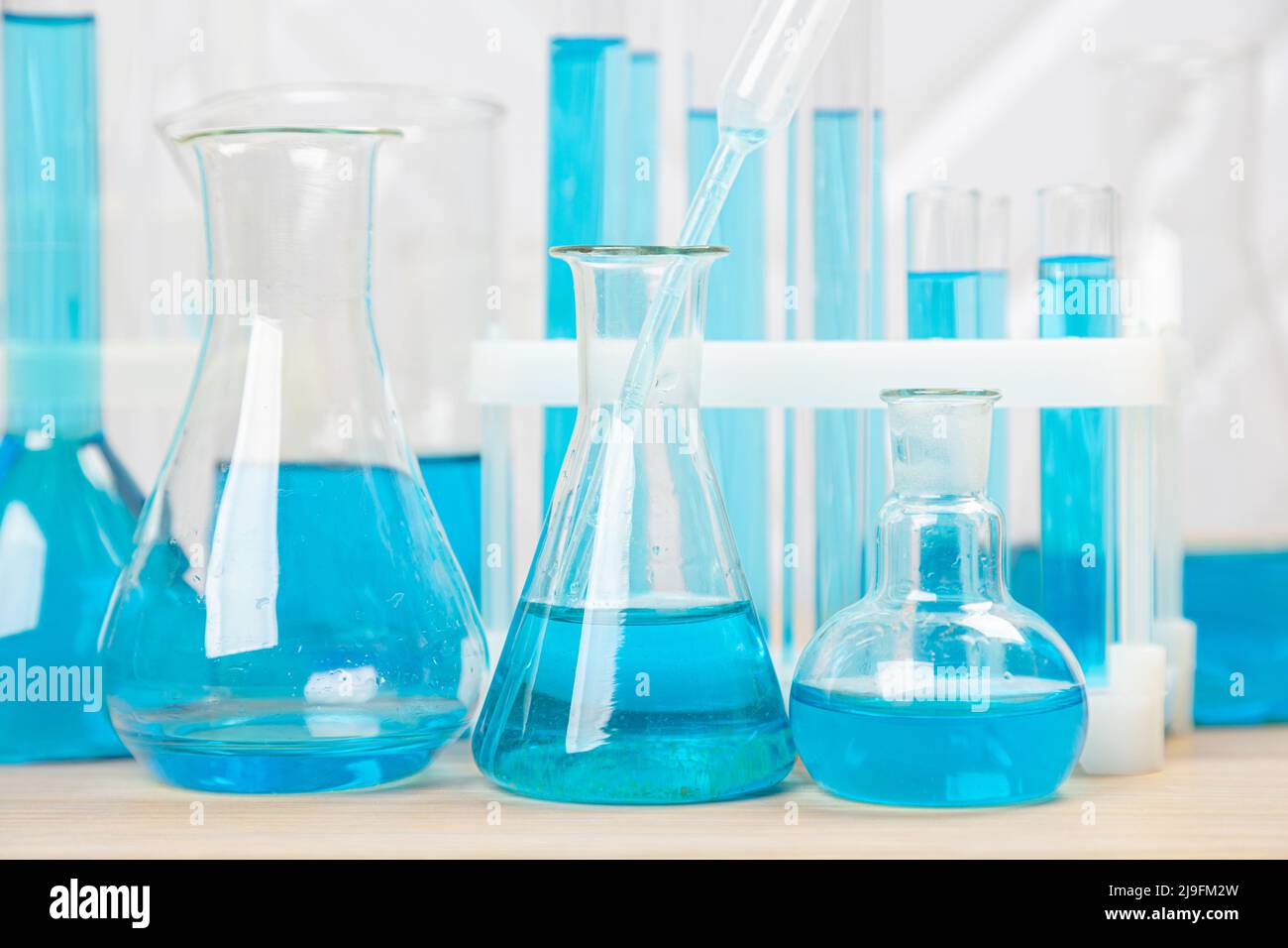 Laboratory glassware with blue liquid in a test tube. scientific ...