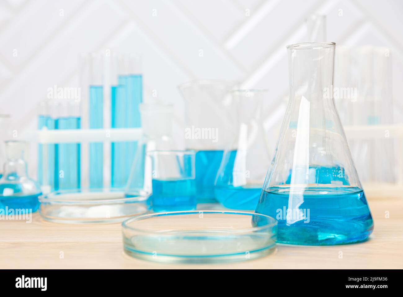 Laboratory glassware with test tubes. flasks, dropper, petri dishes ...