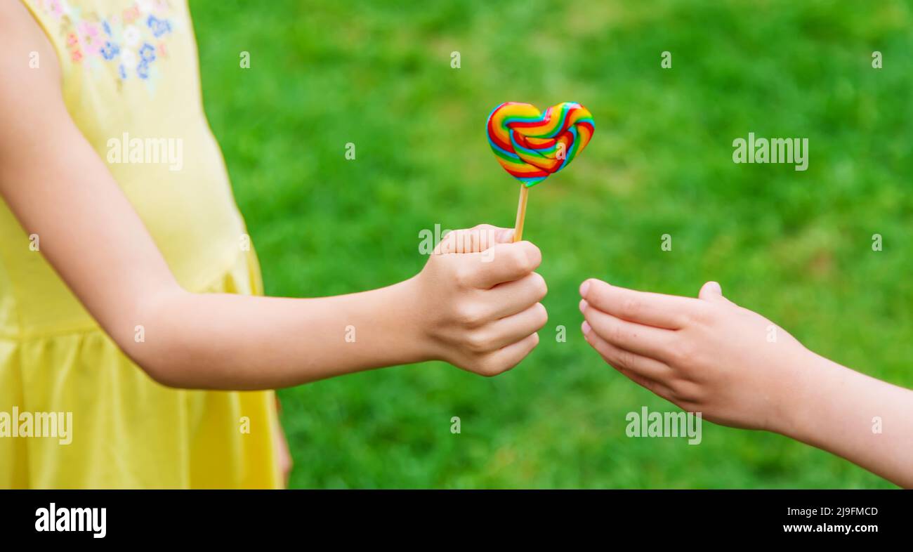 Lollipops in the hands of children. Selective focus. nature Stock Photo ...